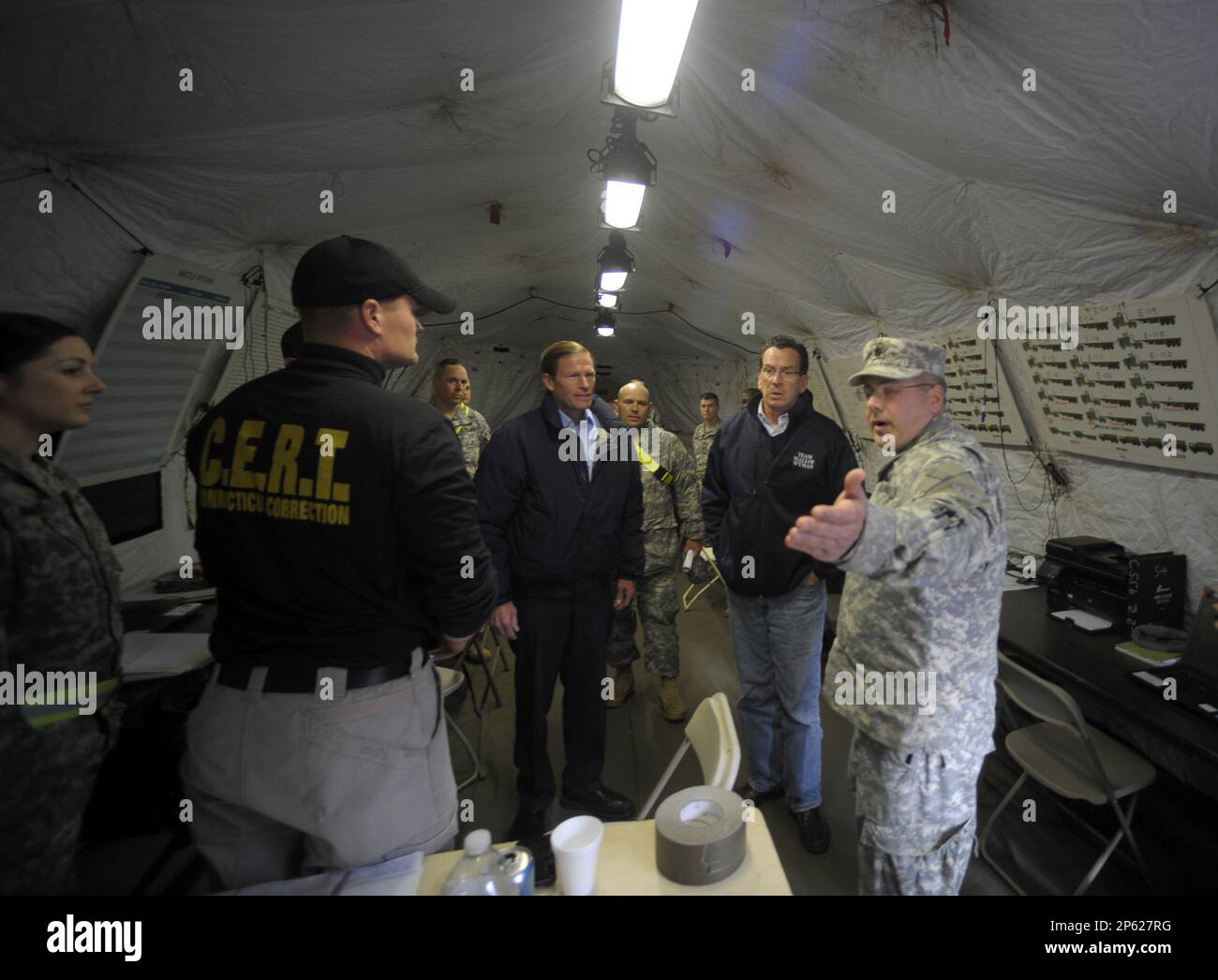 National Guard Lt. Colonel Thomas Dennis, right, points to a board ...