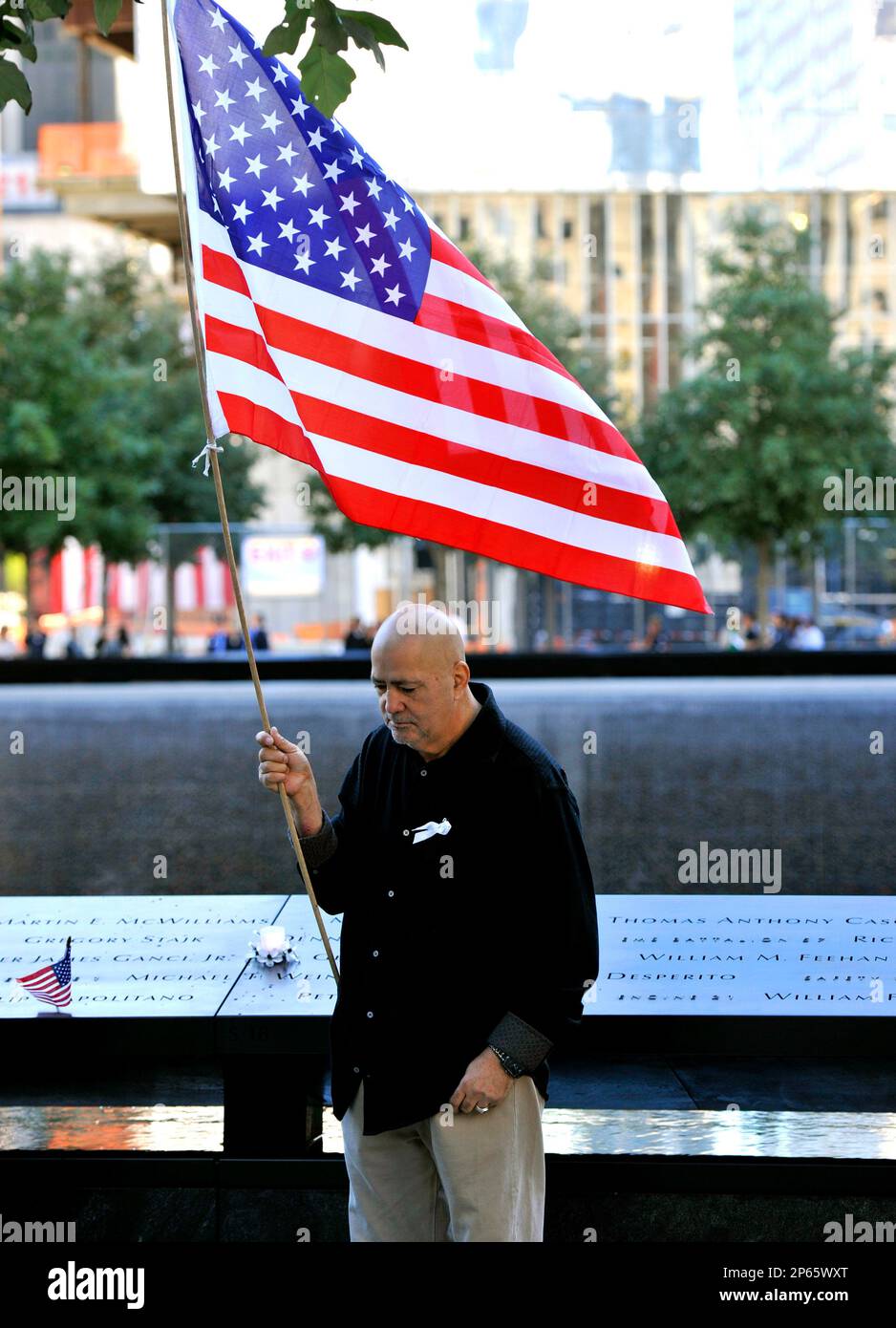 Captain John Lam rolls up an etching of his uncle Stuart Louis on the ...