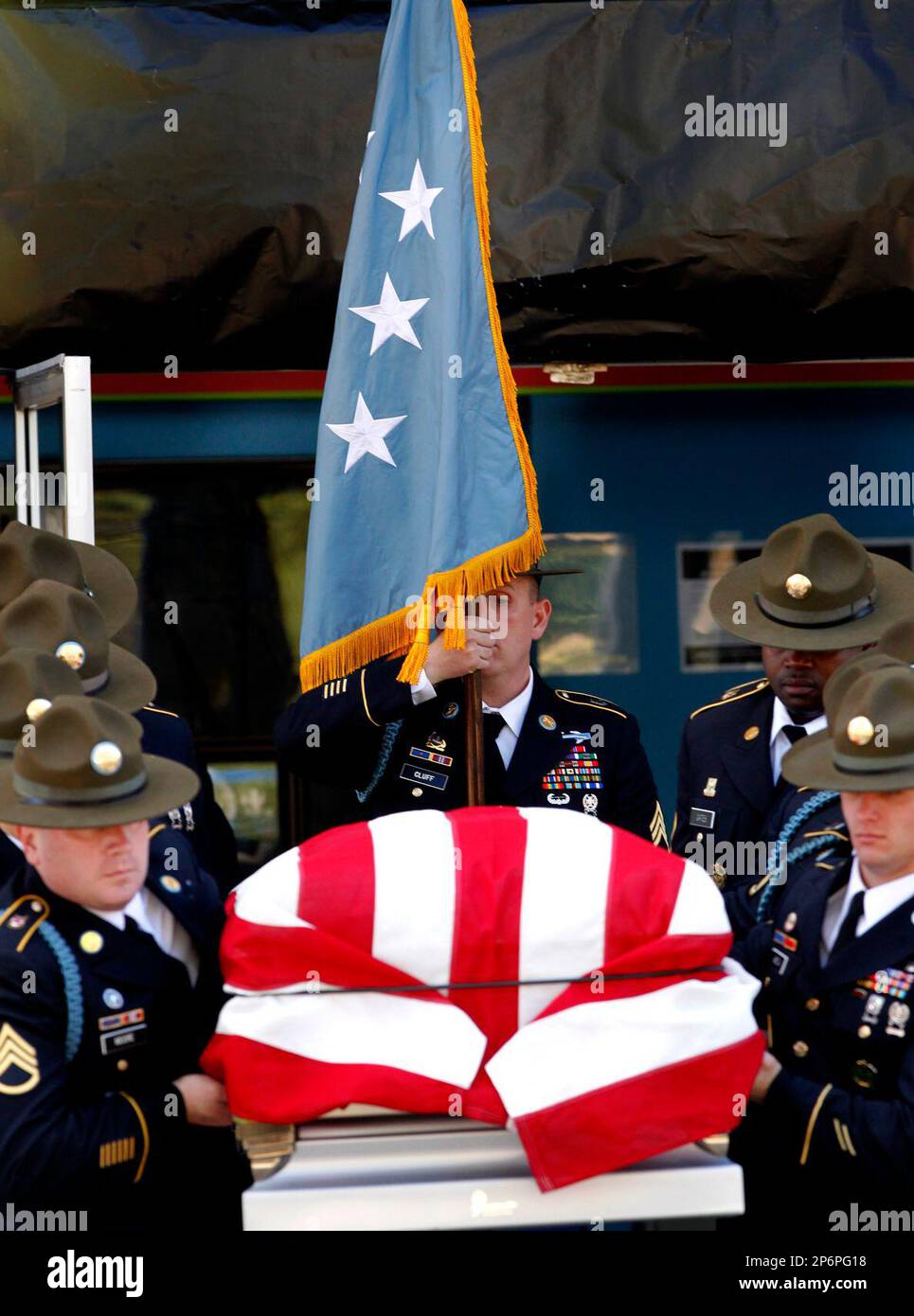 Pallbearers, remove the flag-draped casket from the base theater, after ...