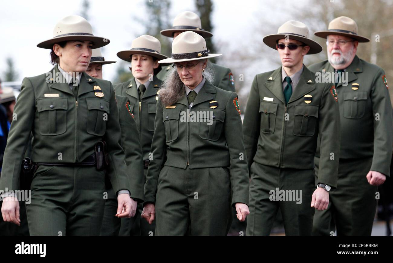 Mount Rainier National Park rangers walk in a procession to a memorial ...