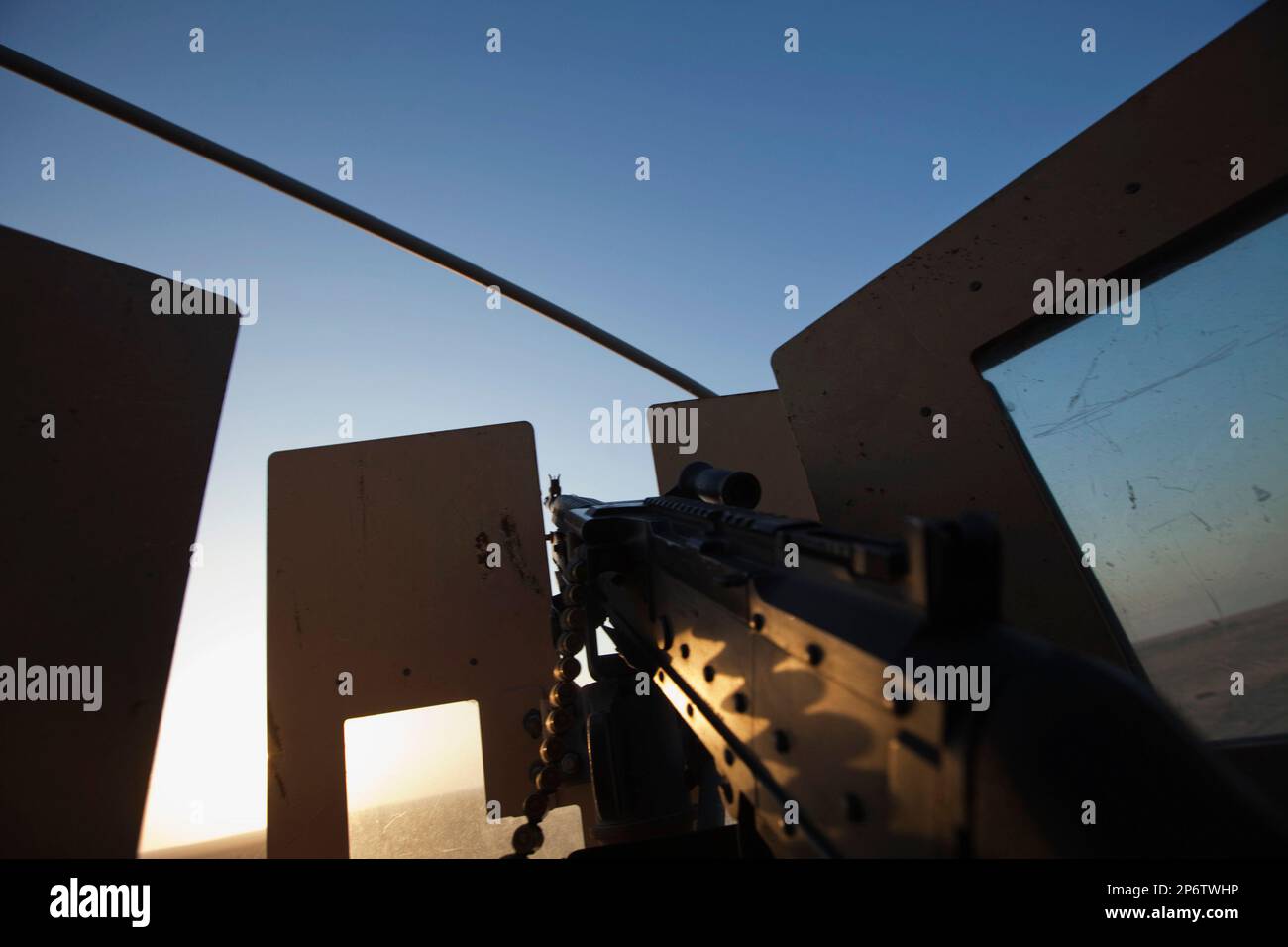 Light from the rising sun hits the side of a turret gun on a Mine ...