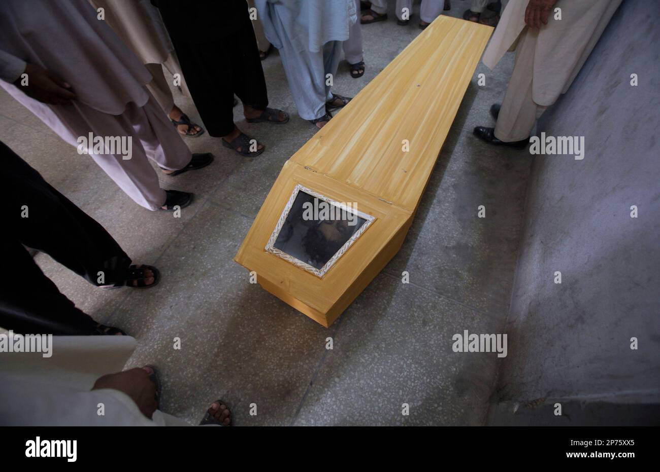 Pakistanis gather around the coffin of a man killed in an explosion in ...
