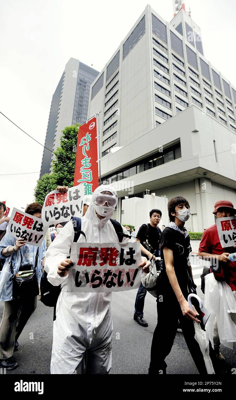 An anti-nuclear protester, wearing a raditoation portect suit with ...