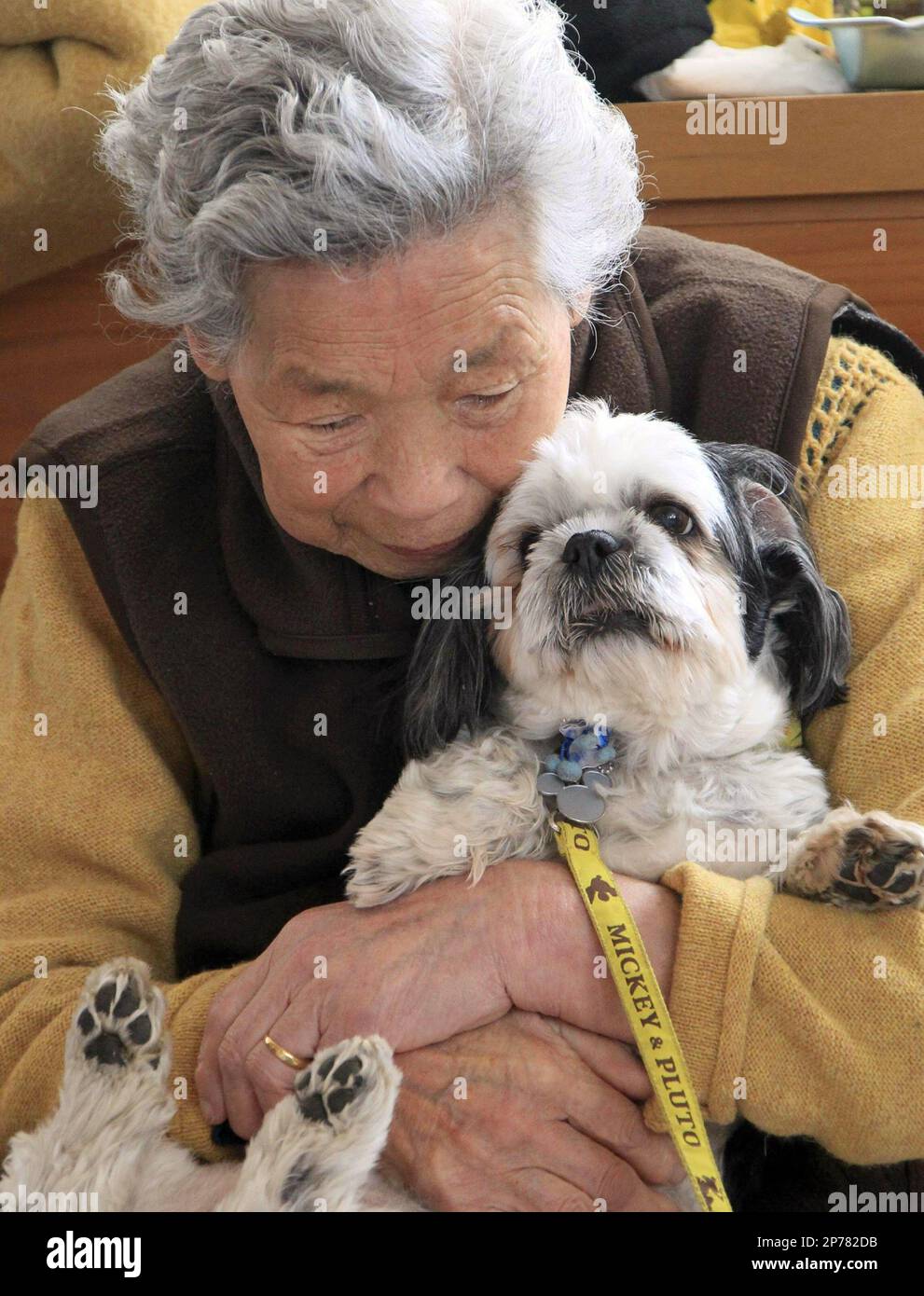 In this Wednesday, March 23, 2011 photo, Tami Akanuma, 83, holds her ...