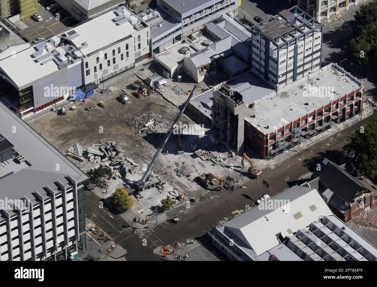 An aerial view shows recovery workers removing the rubble of the ...