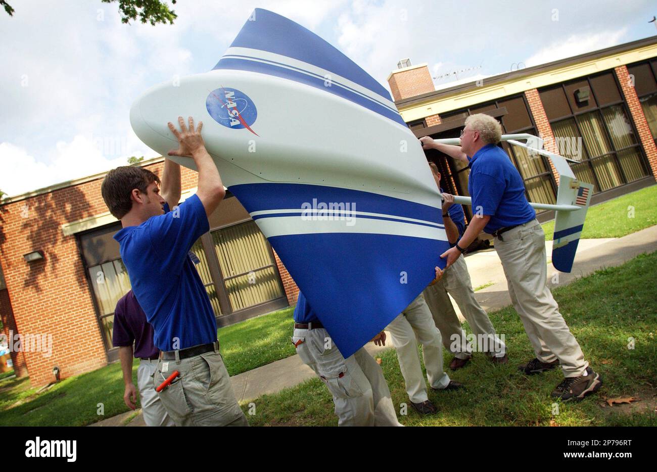 Liam Flanigan, left, and Bob Parks, right, hold the full-size Mars ...