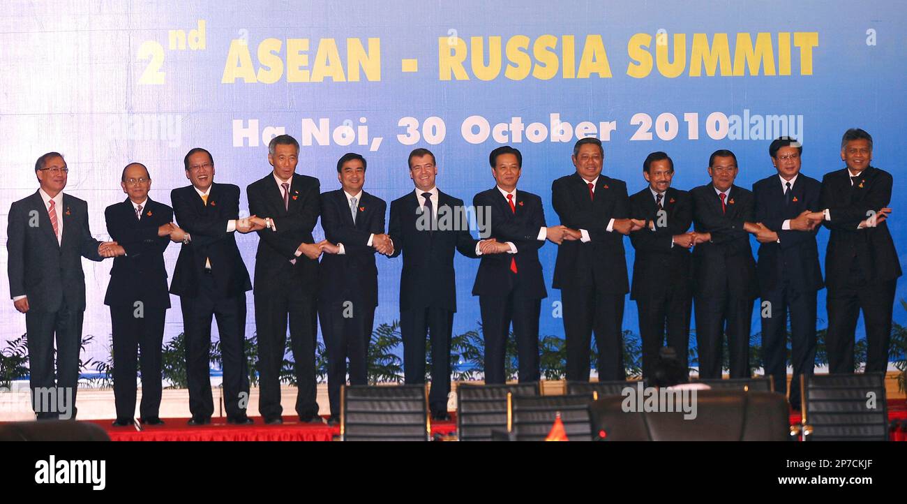 Russian President Dmitry Medvedev, 6th left, joins hands with, from ...