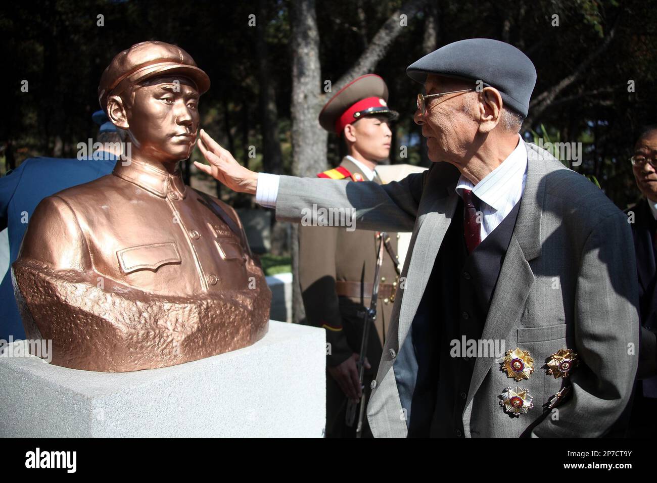 Former Chinese PLA Air Force Commander Wang Hai, veteran of the Chinese voluntary army, touches ...