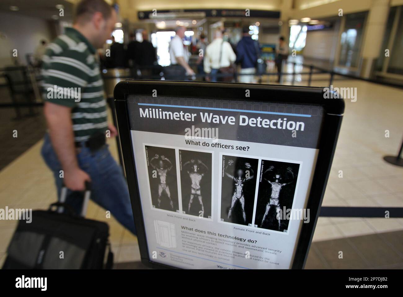 A sign explaining millimeter wave imaging technology is displayed as ...