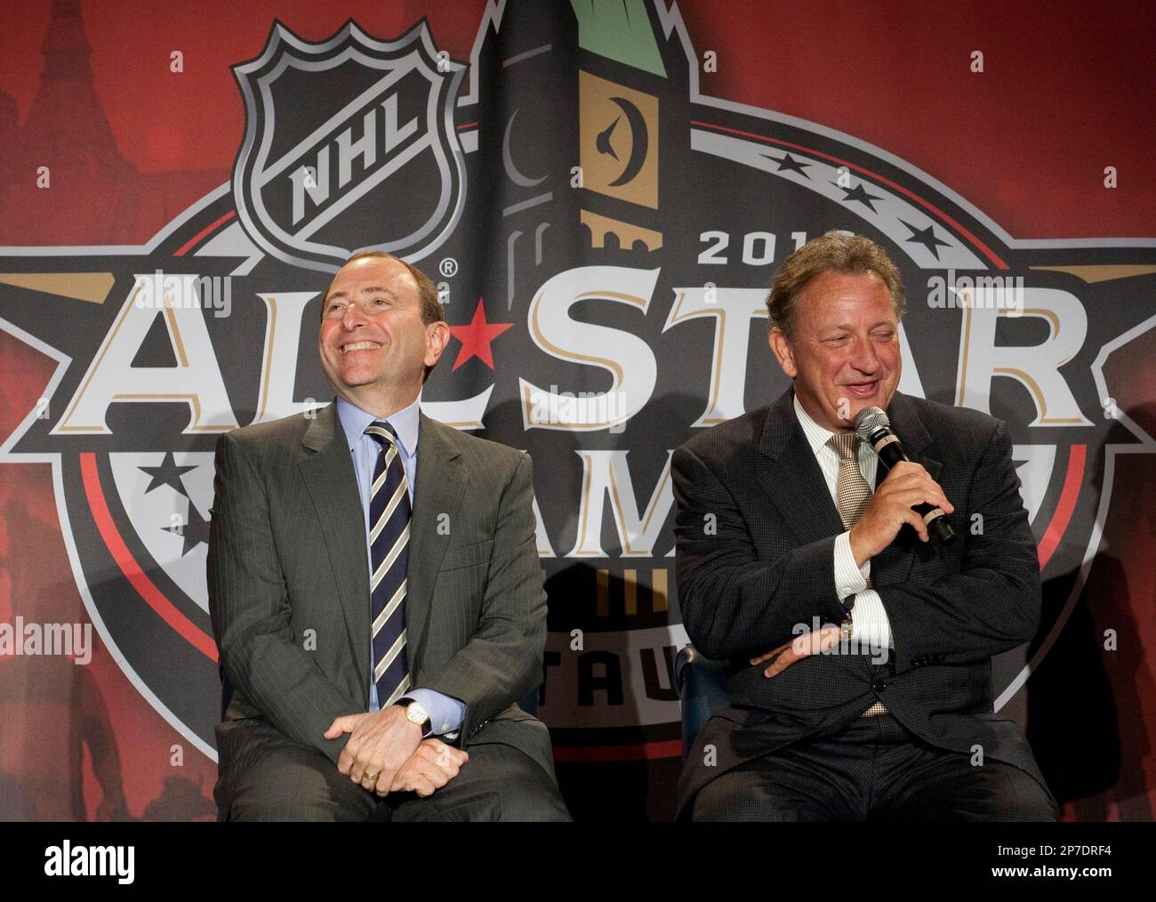 NHL Commissioner Gary Bettman, left laughs as he listens to Ottawa ...