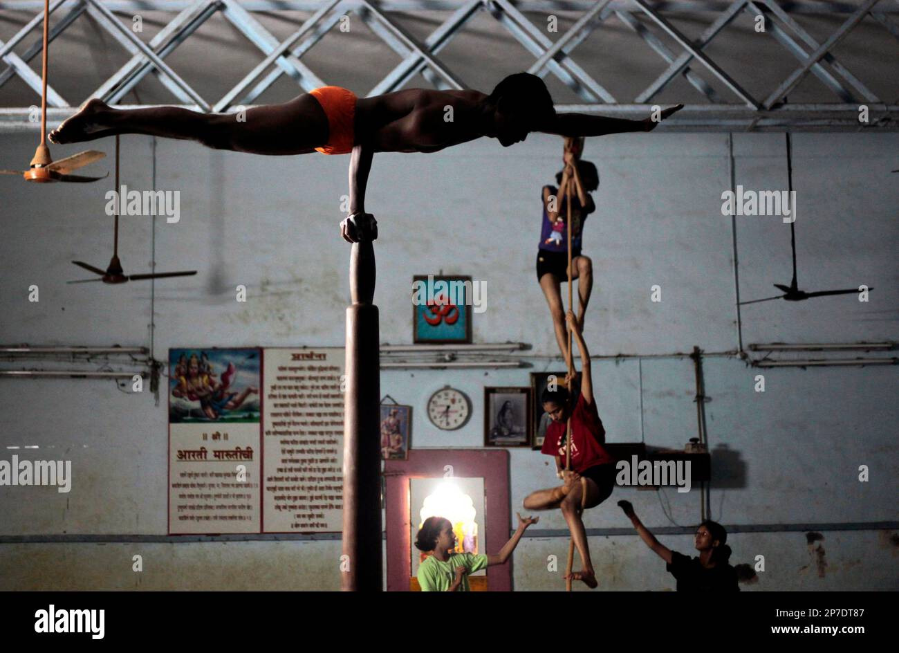 Indian gymnasts perform Mallakhamb at a gymnasium in Mumbai, India ...