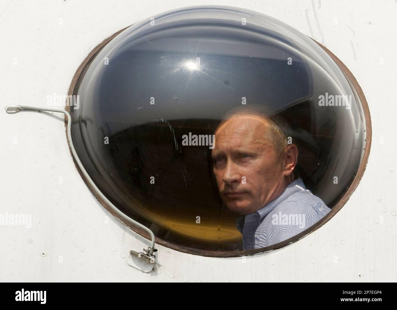 Russian Prime Minister Vladimir Putin looks through a blister window of ...