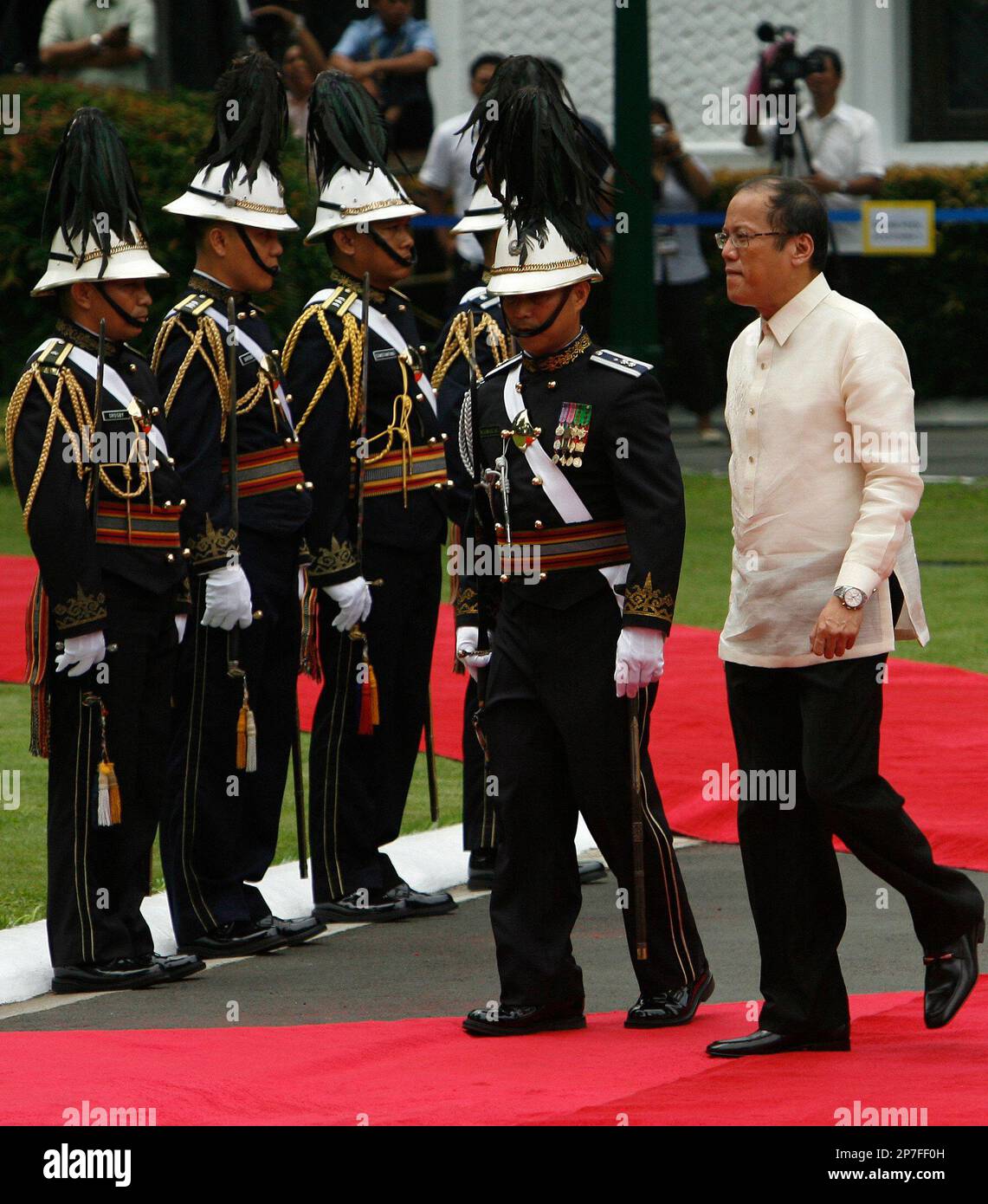New Philippine President Benigno Aquino III, right, walks past military ...