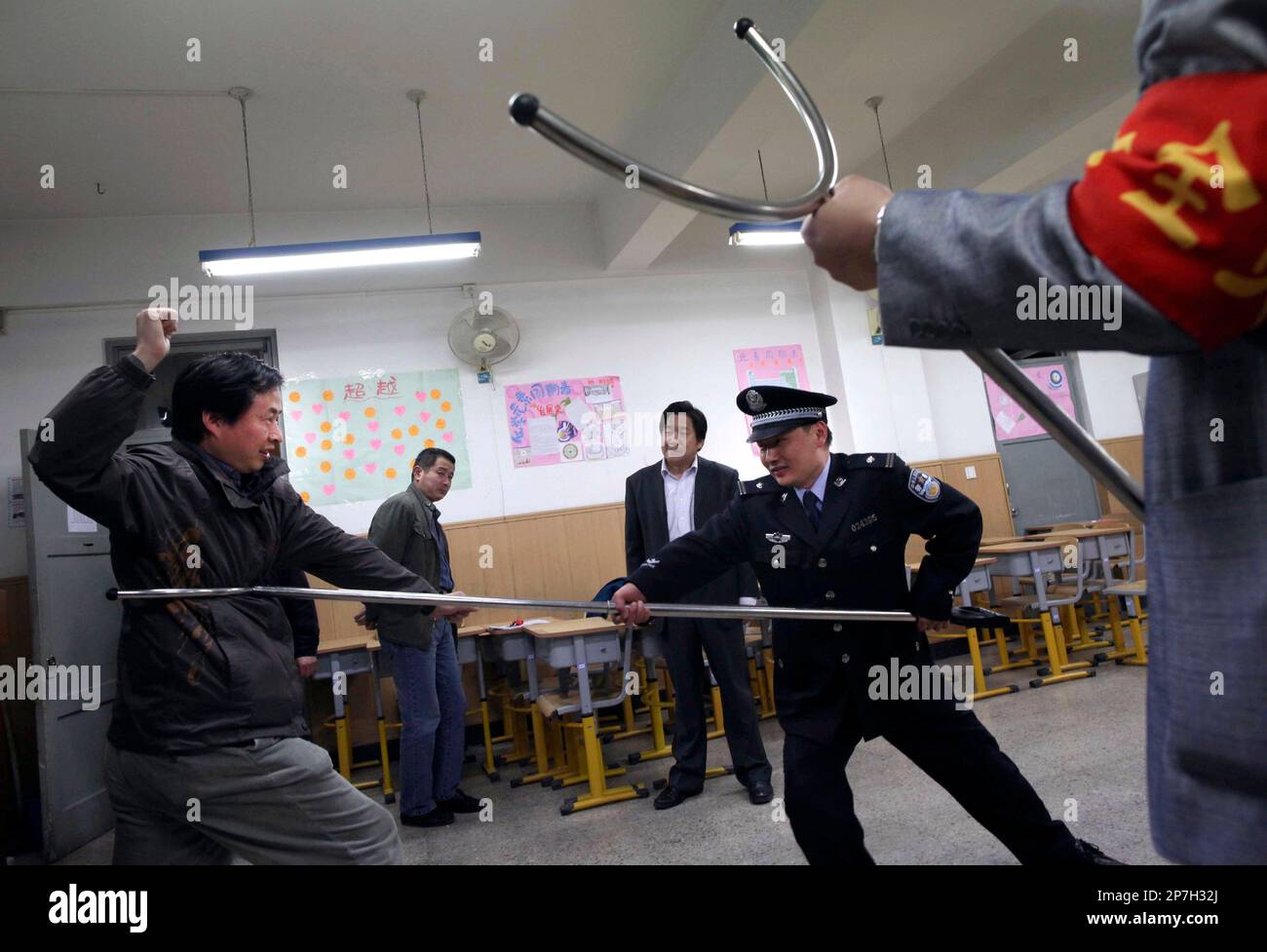 A Chinese police officer demonstrate the use of a "police restraint ...