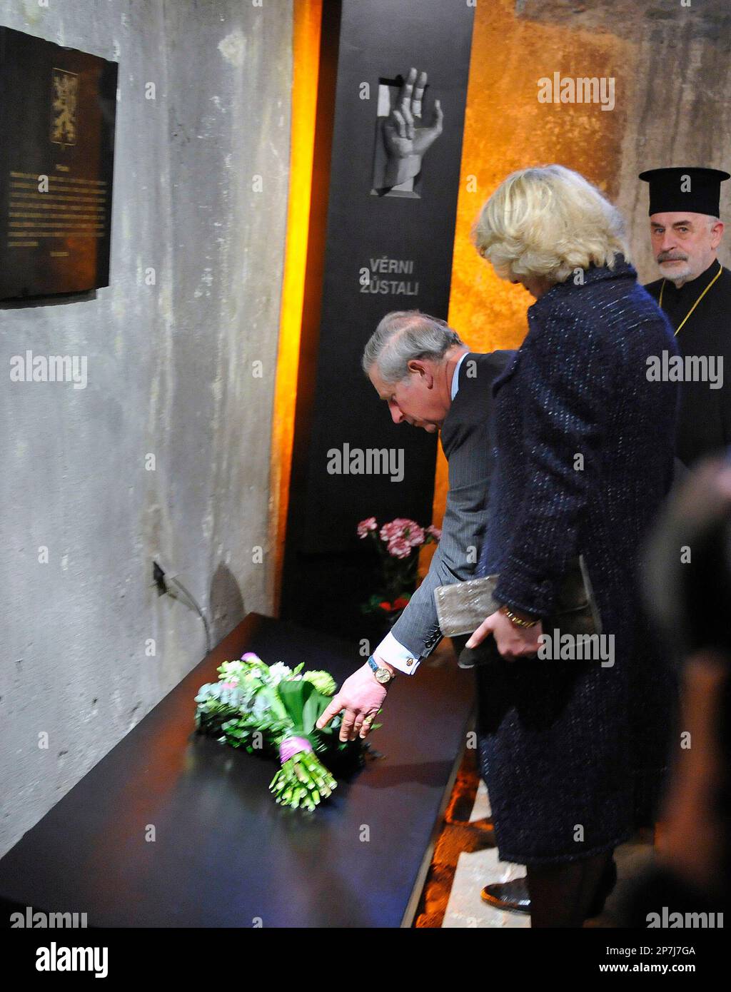 Britain's Prince Charles lays a bouquet as his wife Camilla, Duchess of ...