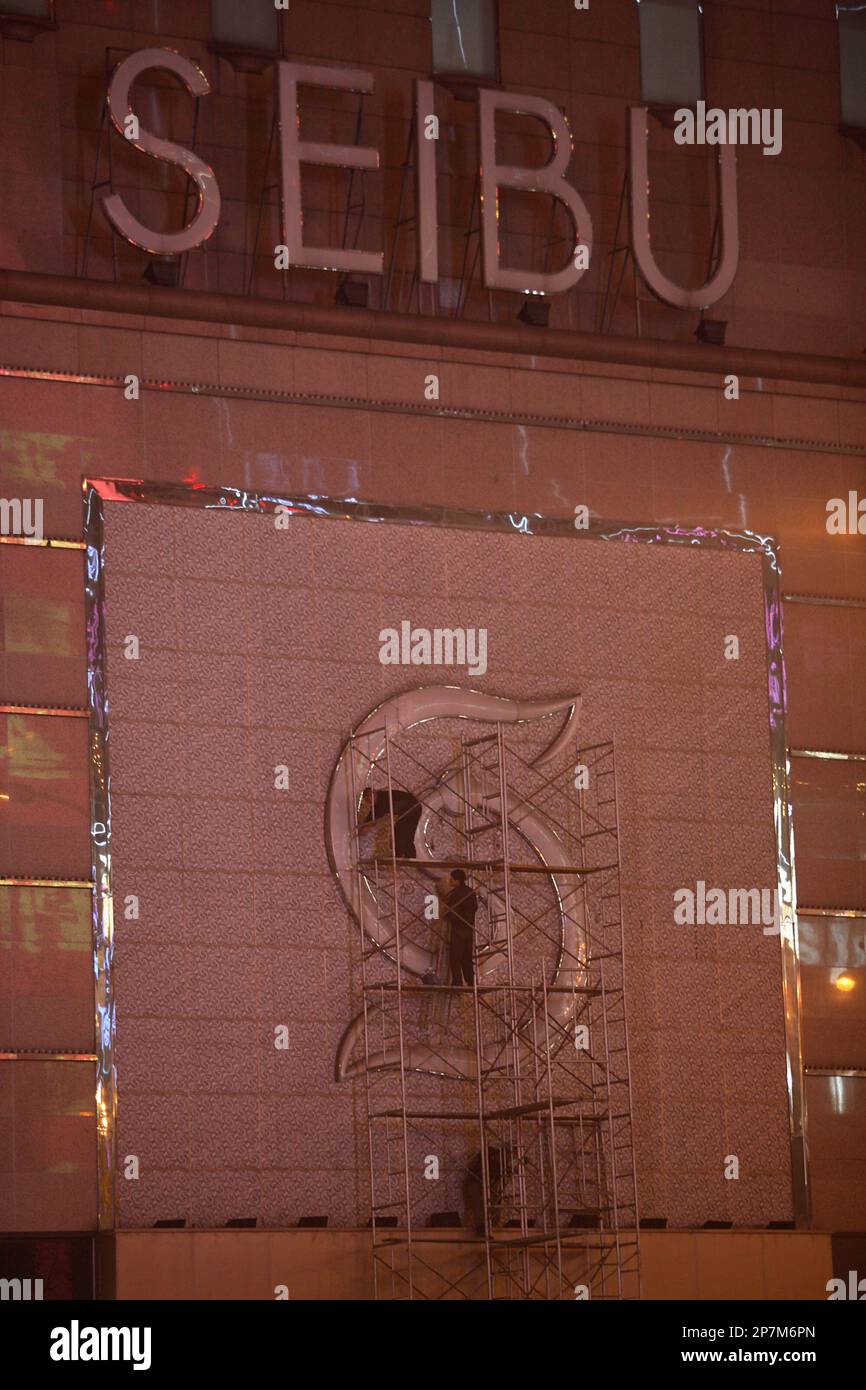 Workers dismantle the Seibu logo at the Seibu Department Store in ...