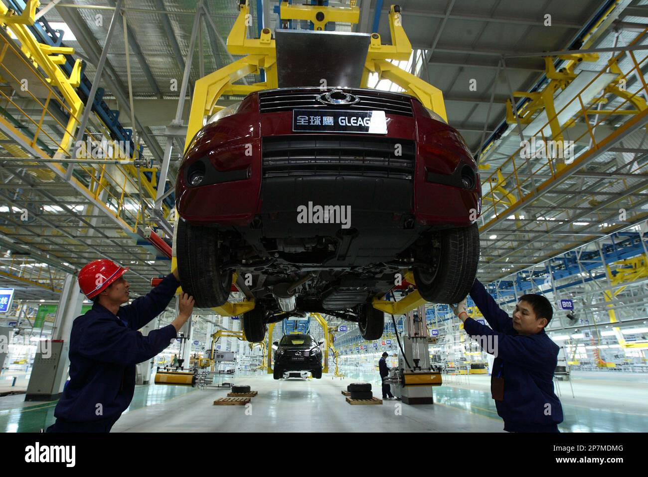 Workers work on the production line of Geely GX718 SUV in Chengdu in ...