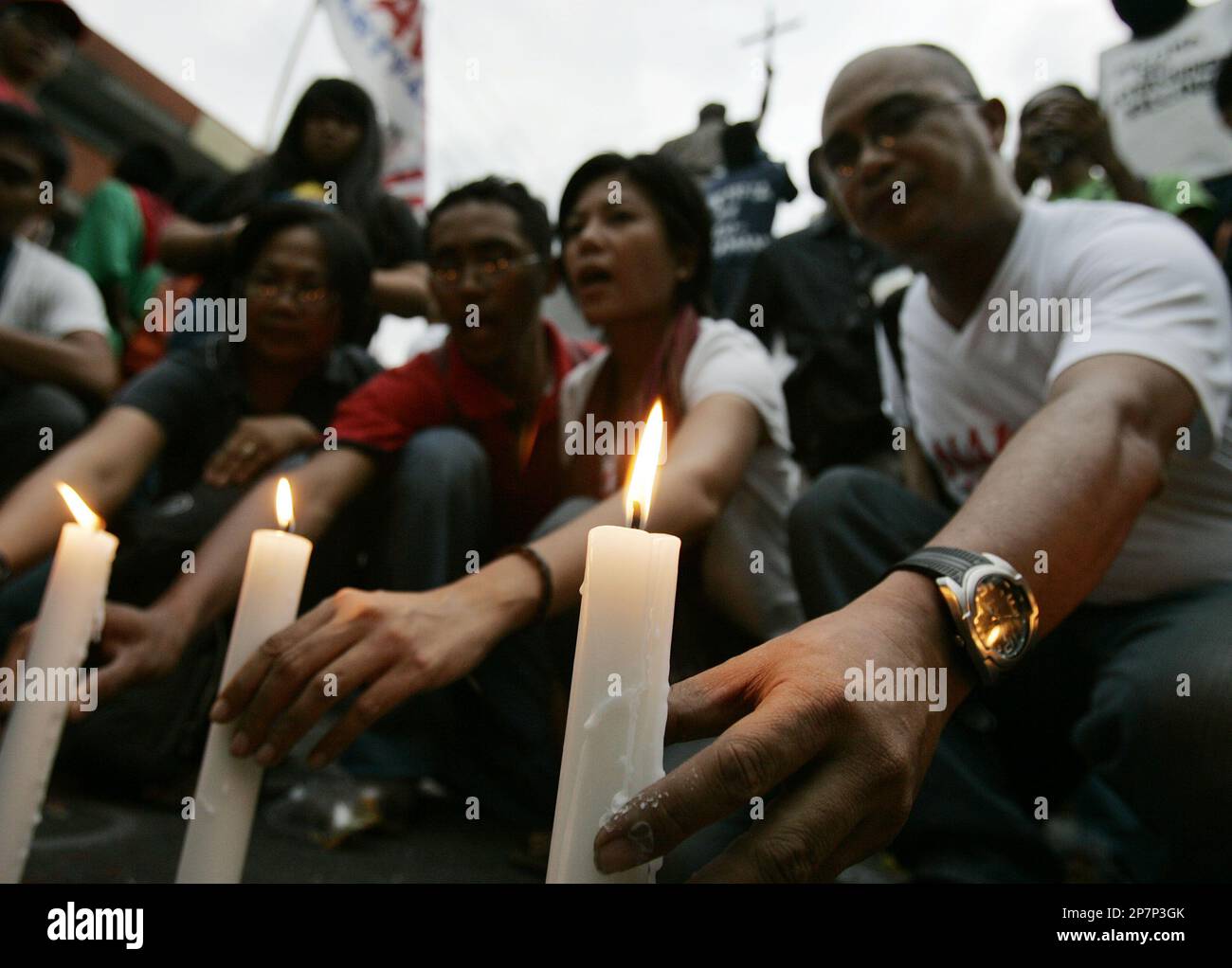 Filipino activists light candles near the Malacanang presidential ...
