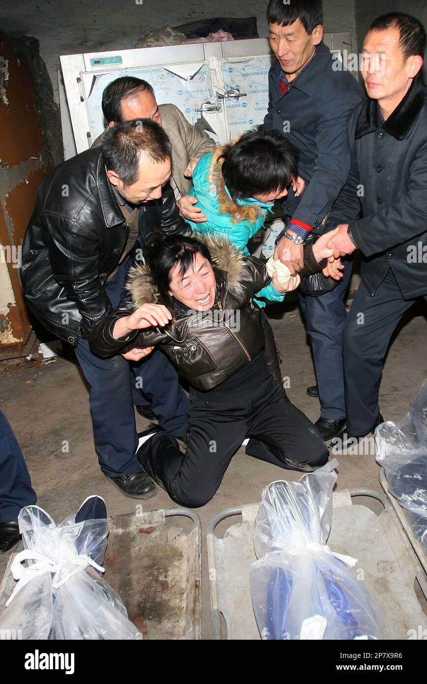 A woman grieves over her son killed in a blast at the Tunlan Coal Mine ...