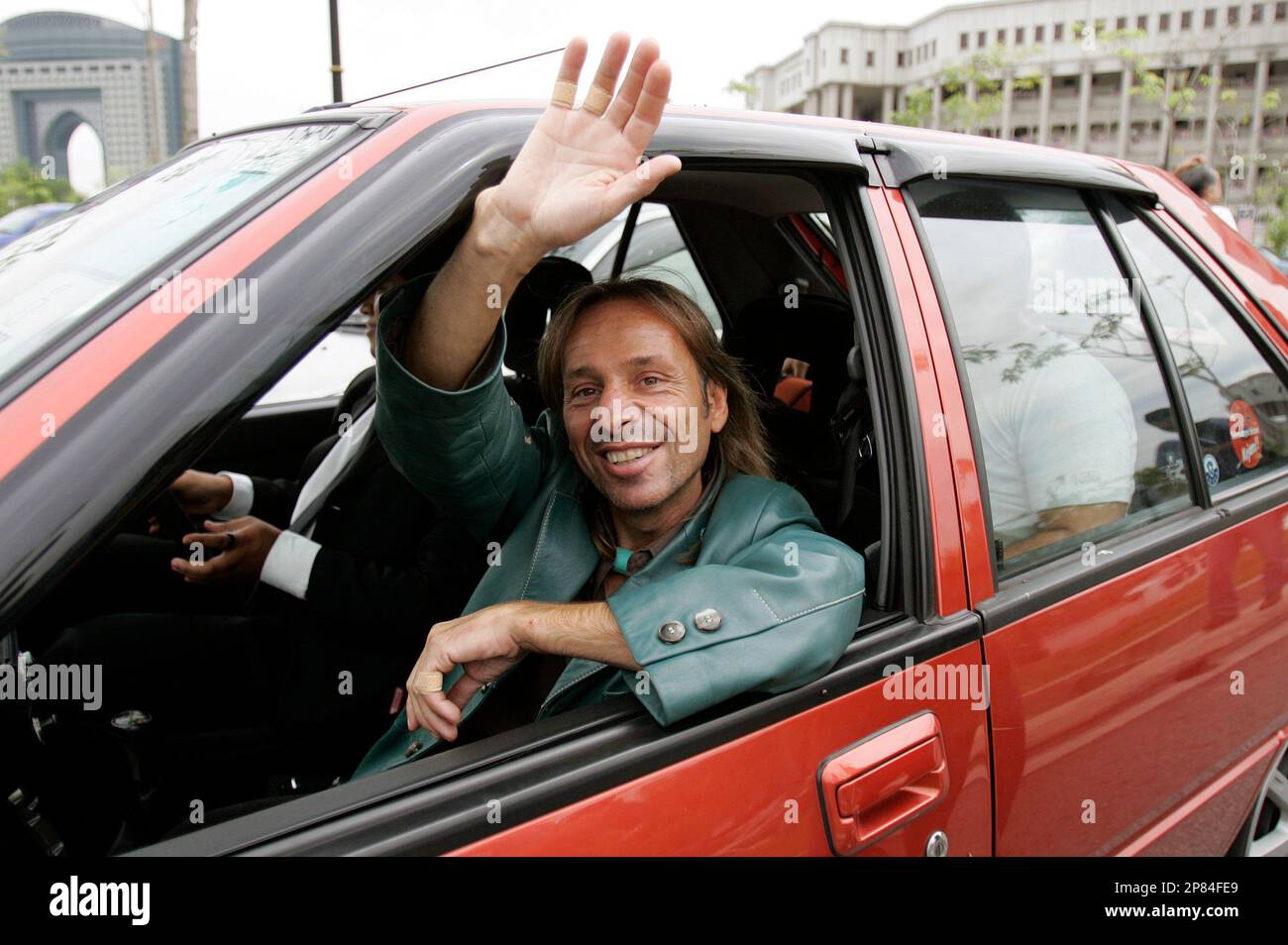 French climber Alain Robert, known as "Spiderman" waves as he leaves ...