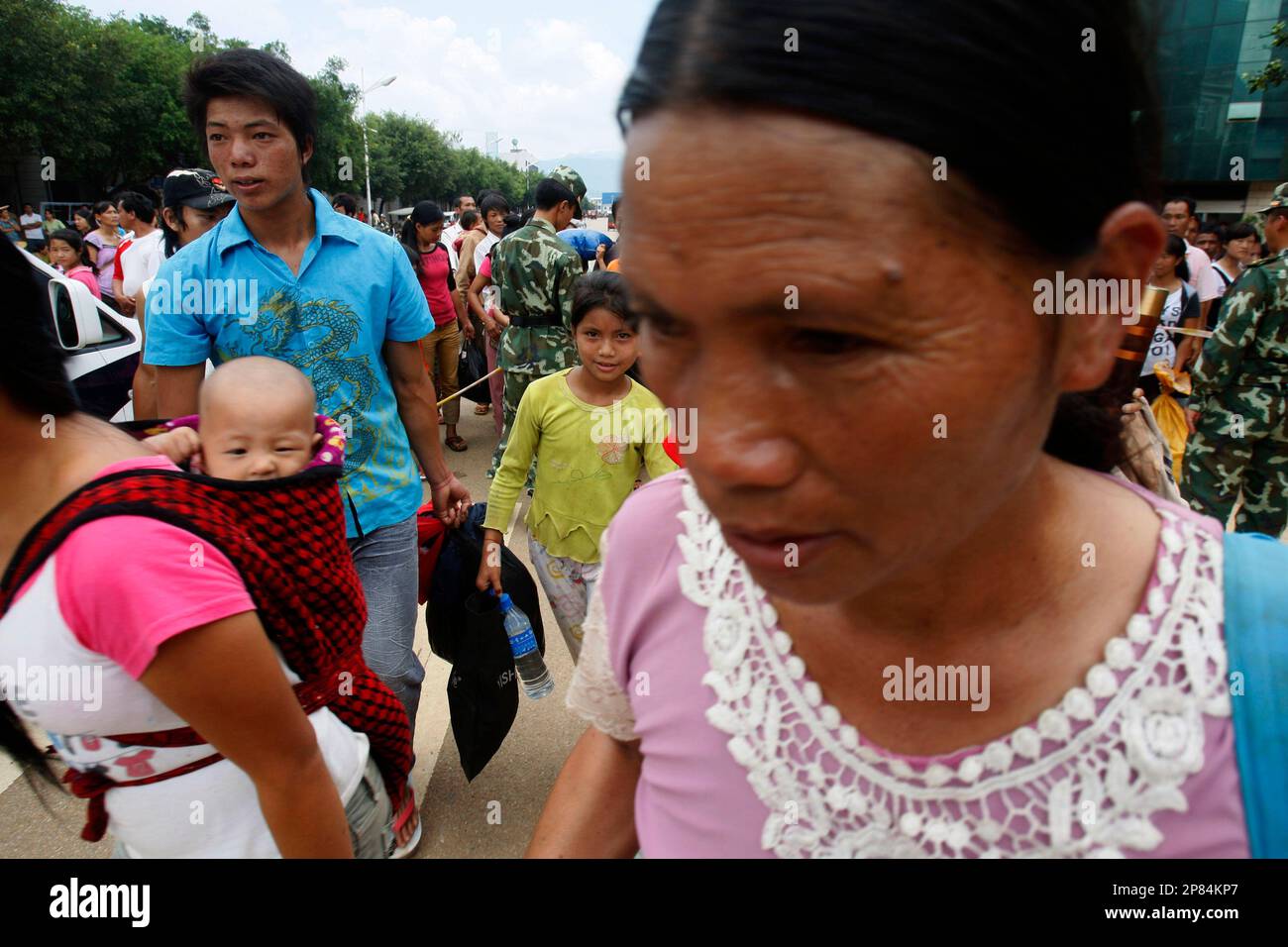 Myanmar refugees walk towards the China-Myanmar border gates to return ...