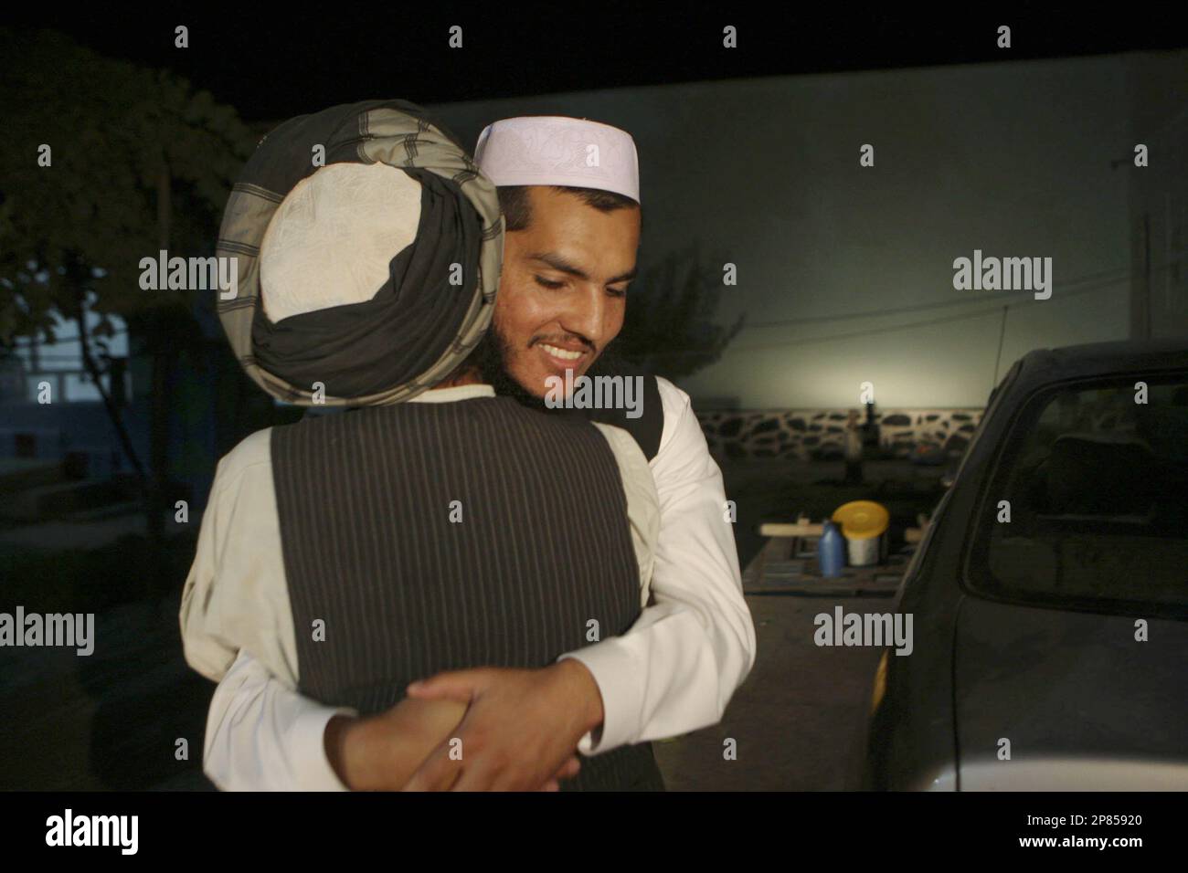 Former Guantanamo detainee Mohammed Jawad, right, is welcomed by family and friends in Kabul ...