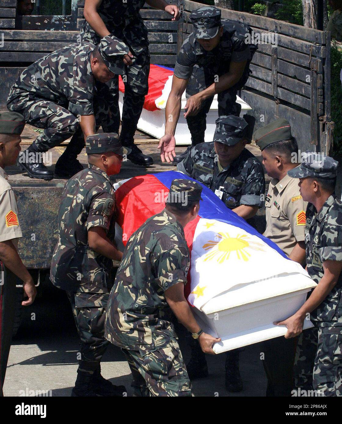 Philippine Marines carry the flag-draped coffins of soldiers killed in ...