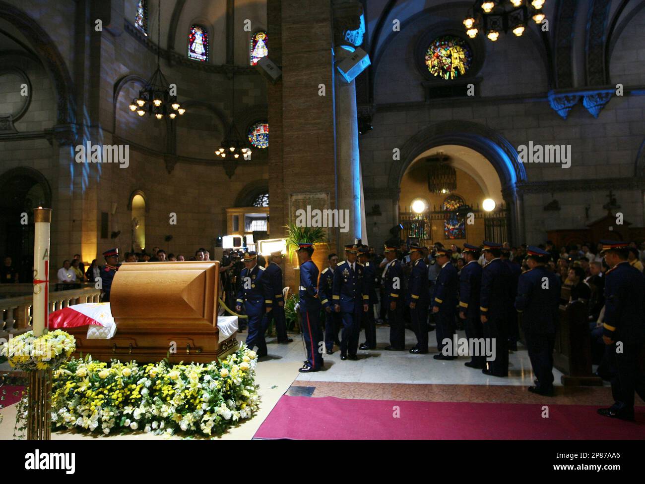 Philippine police officers view the remains of the late President ...