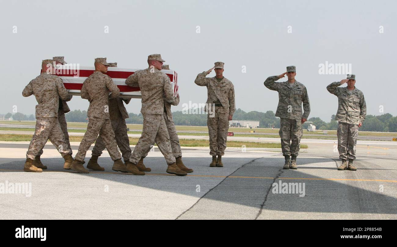 A Marine Corps carry team carries the transfer case containing the ...