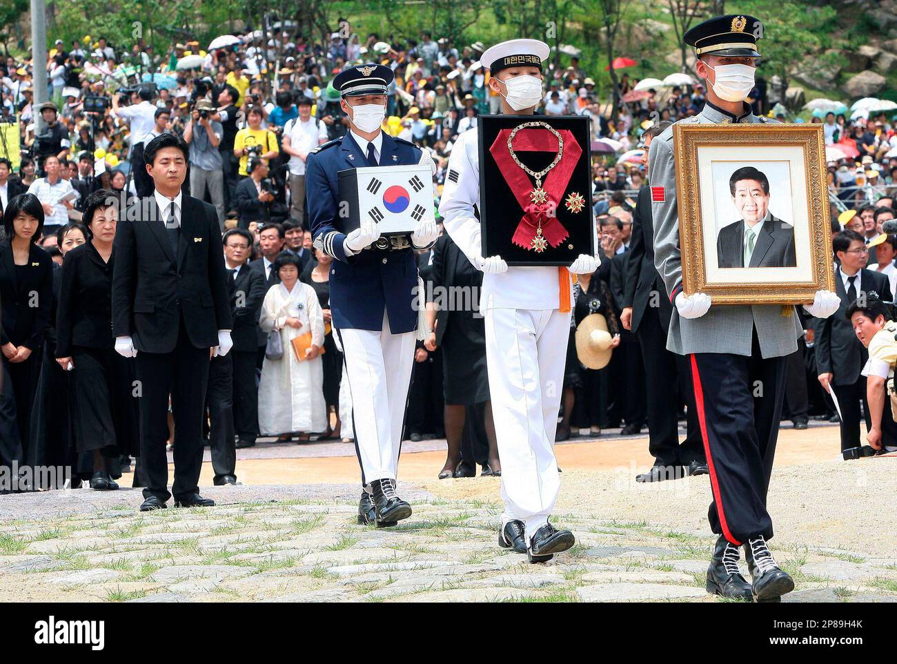 A late South Korean President Roh Moo-hyun's portrait is carried by honor guards as Roh Gun-ho ...