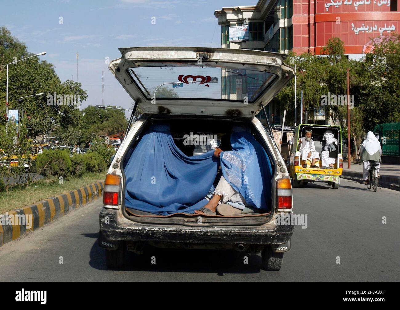 Afghan women are being transported on the back of taxi car in Jalalabad ...