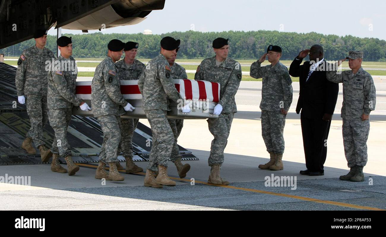 An Army Corps carry team carries the transfer case containing the ...