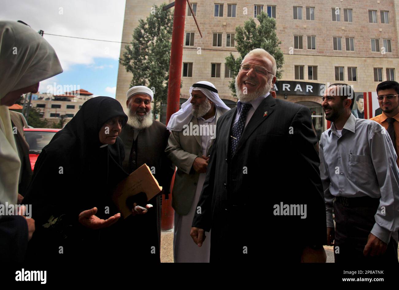 Palestinian parliament speaker Abdel Aziz Duaik, centre, reacts as he ...