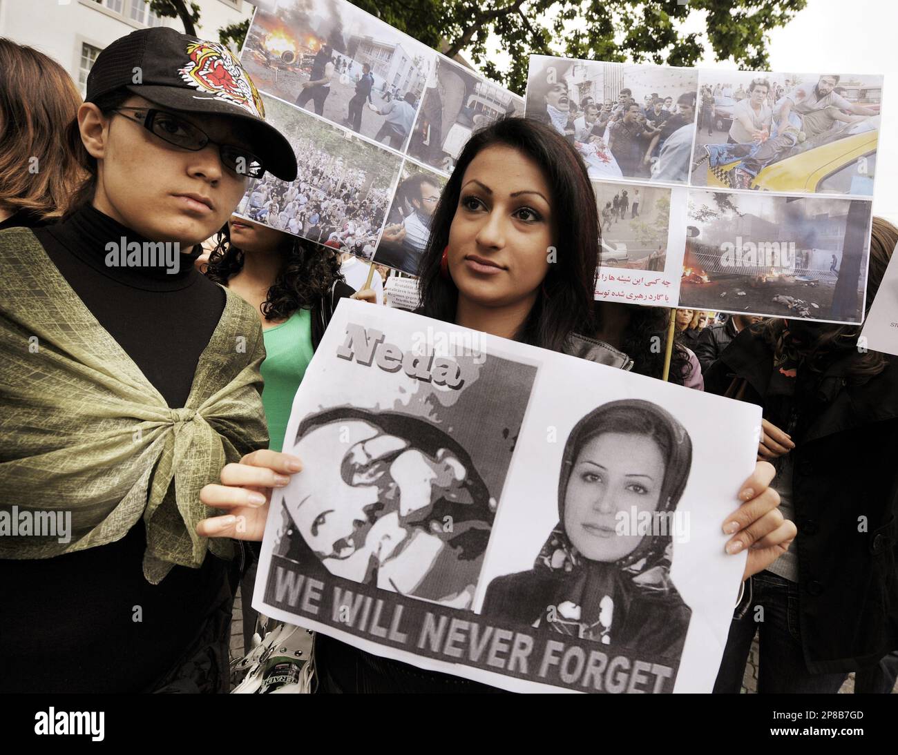 People of Iranian origin hold images purporting to show Neda Agha ...