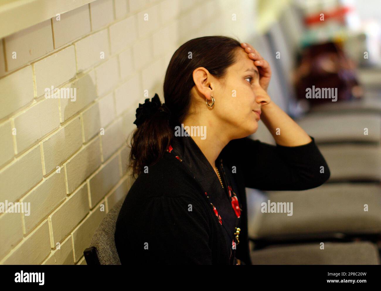 A unidentified Romanian woman speaks to the media at a Belfast City ...