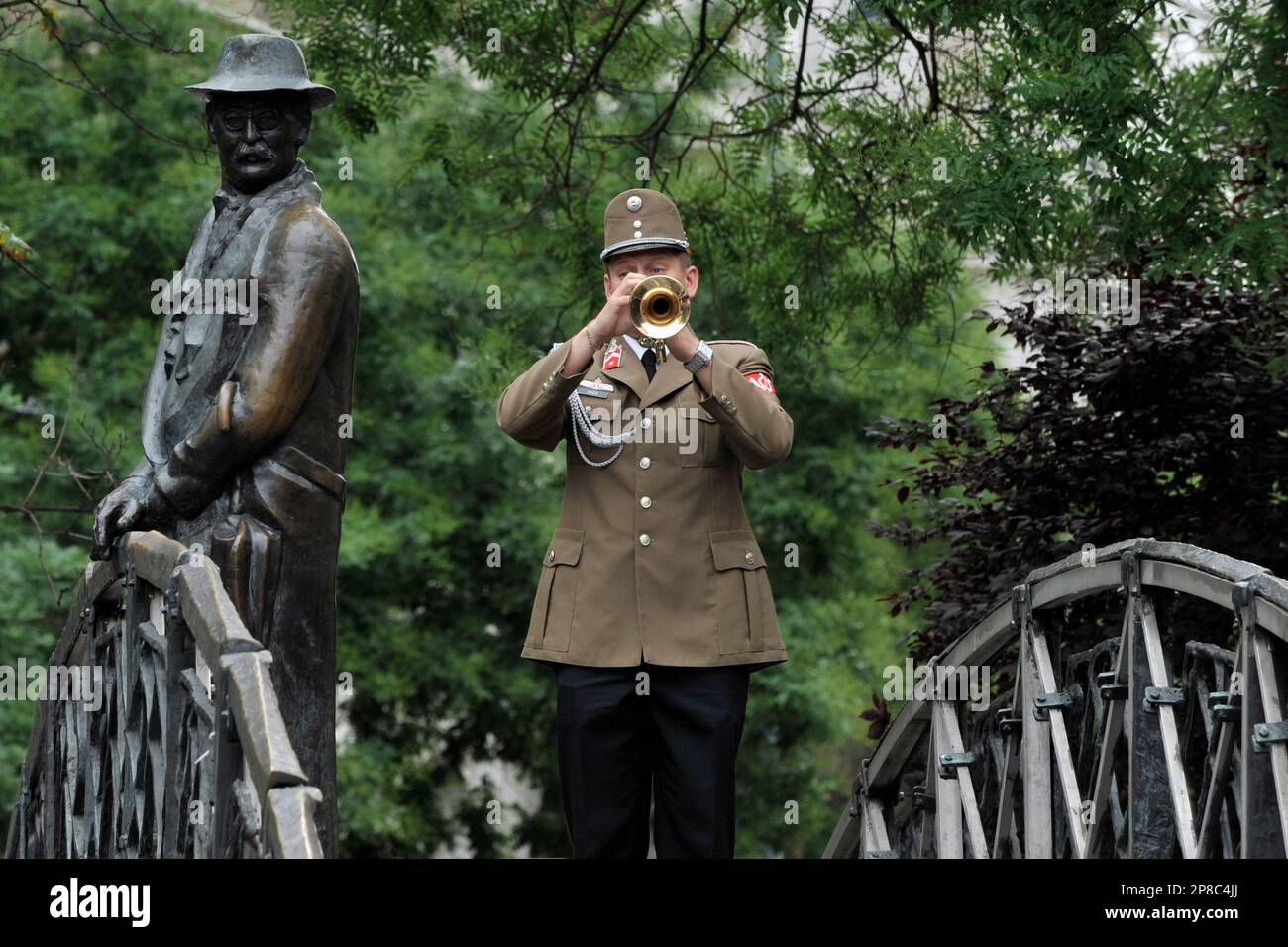 A Hungarian guard of honor plays the trumpet during a commemoration of ...