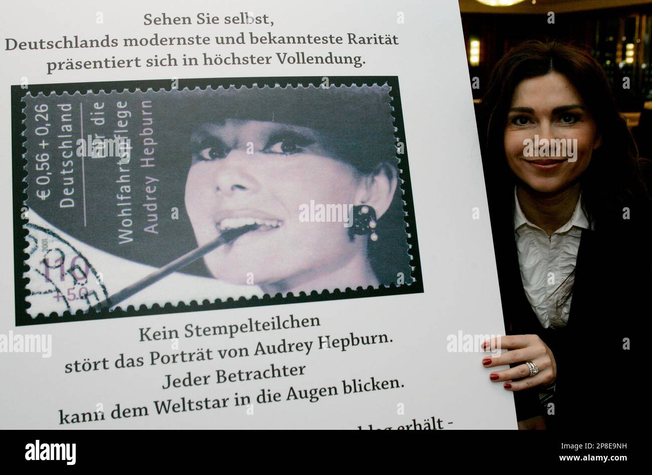 German auctioneer Elisabeth Schlegel holds an enlarged copy of the ...