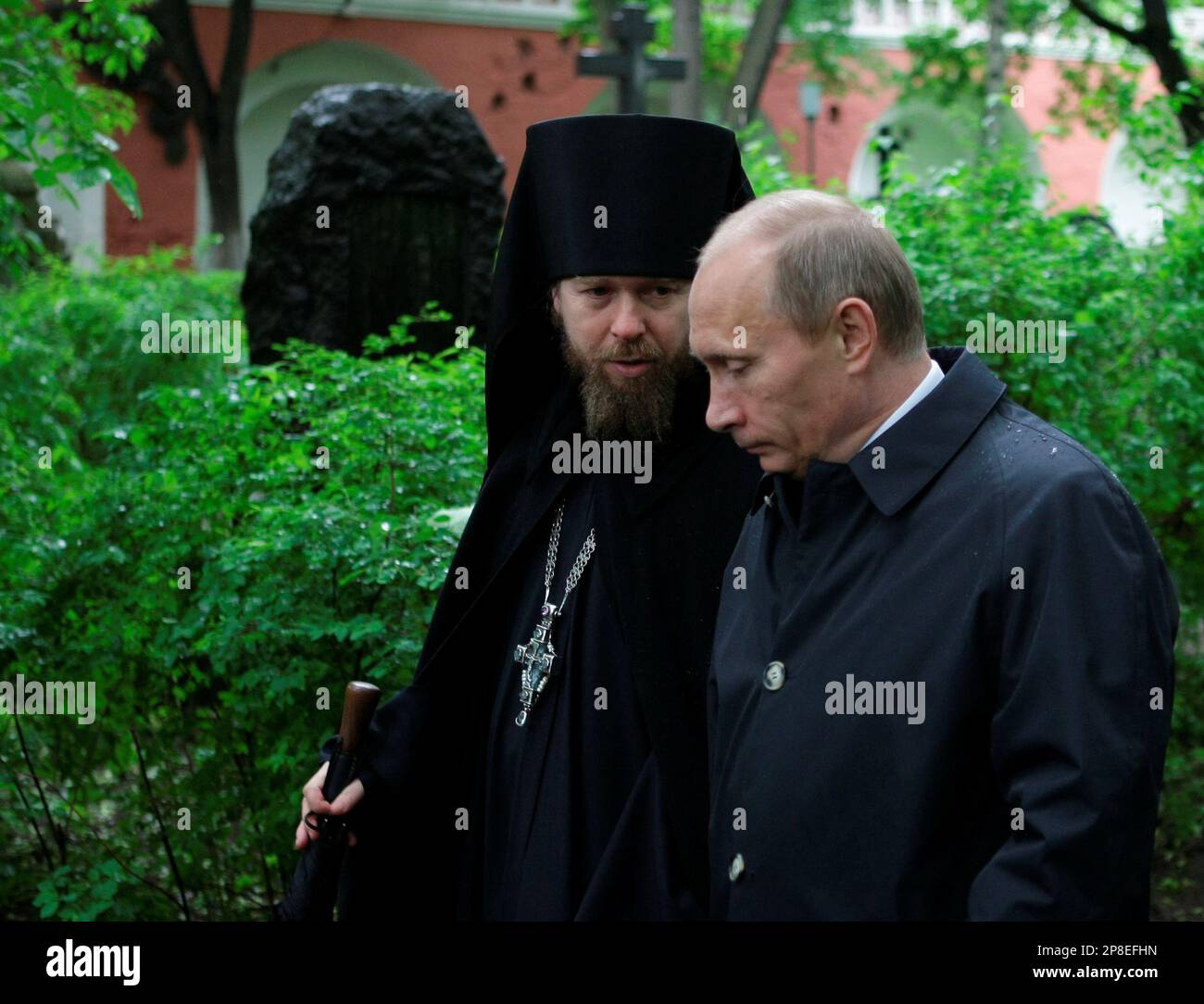 Russian Prime Minister Vladimir Putin speaks with an Orthodox Church ...
