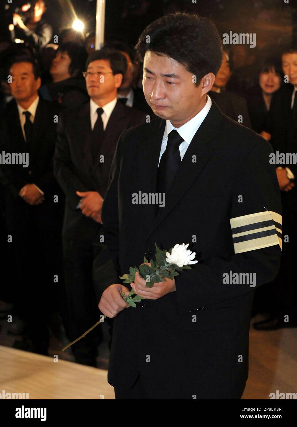 Former President Roh Moo-hyun's son Roh Gun-ho holds a flower at ...