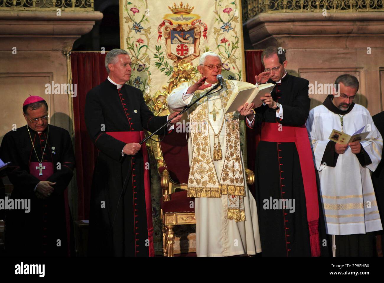 Pope Benedict XVI prays in front of the aedicule, flanked by, on the ...