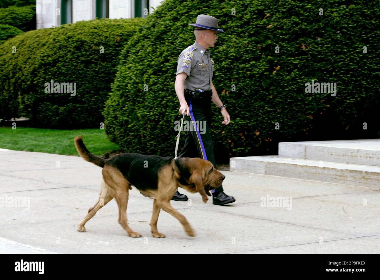 Connecticut state Trooper First Class Kevin Eklund walks his bloodhound ...