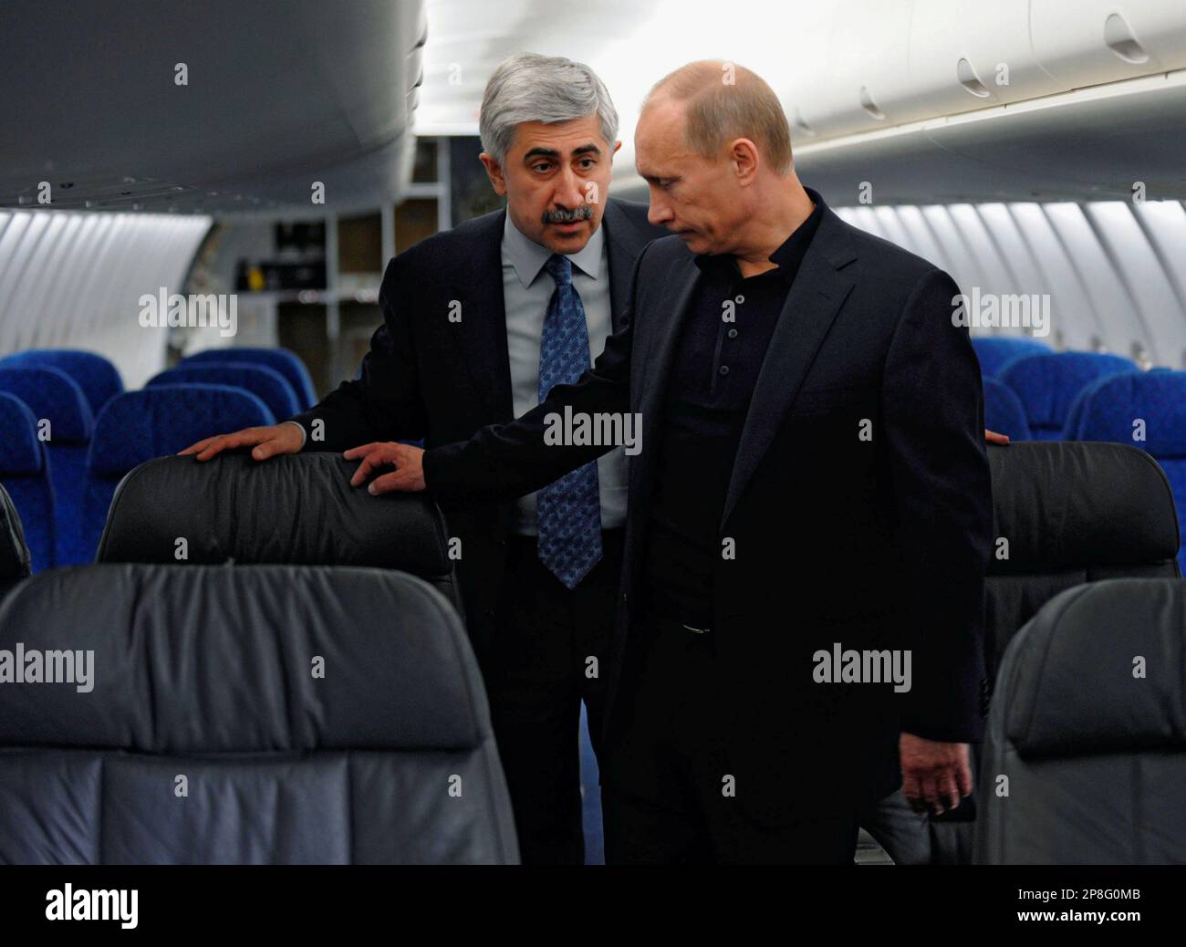 Russian Prime Minister Vladimir Putin, right, listens to Mikhail ...