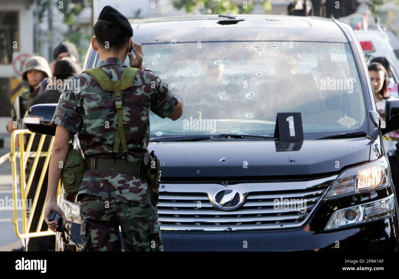 A Thai soldier looks at the bullet-riddled automobile of Sondhi ...