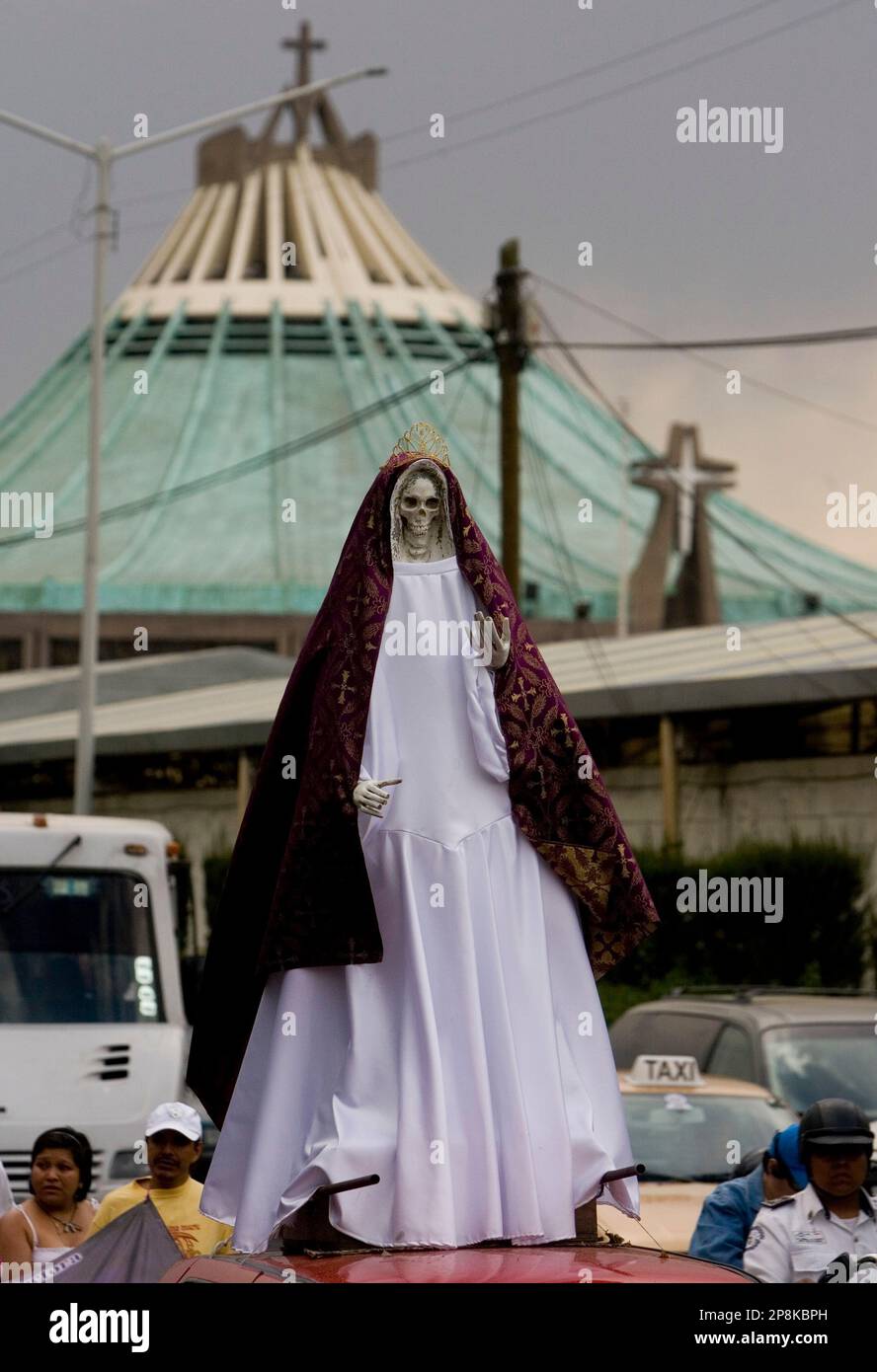 Worshippers carry an image of Mexican folk saint "Santa Muerte" or ...
