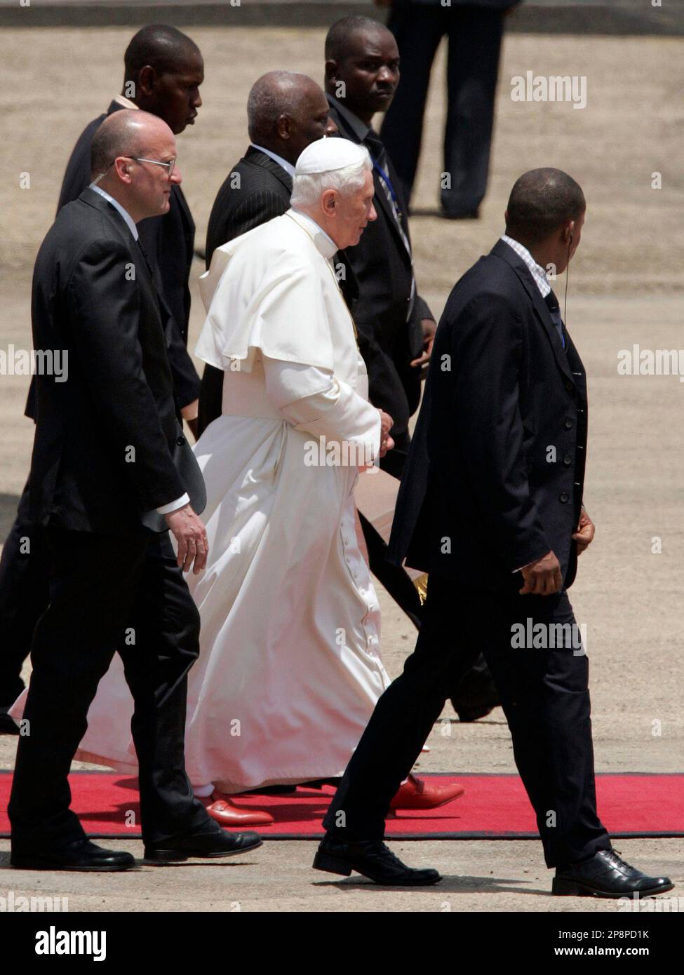 Pope Benedict XVI, center, walks with Angolan President Jose Eduardo ...