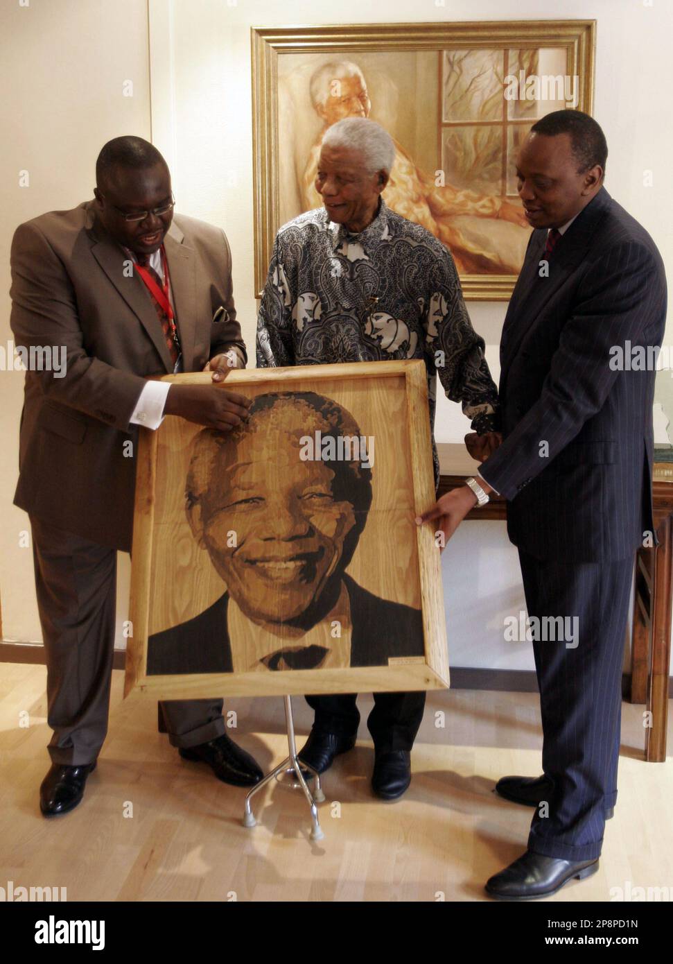 Former South African President Nelson Mandela, center, is presented ...