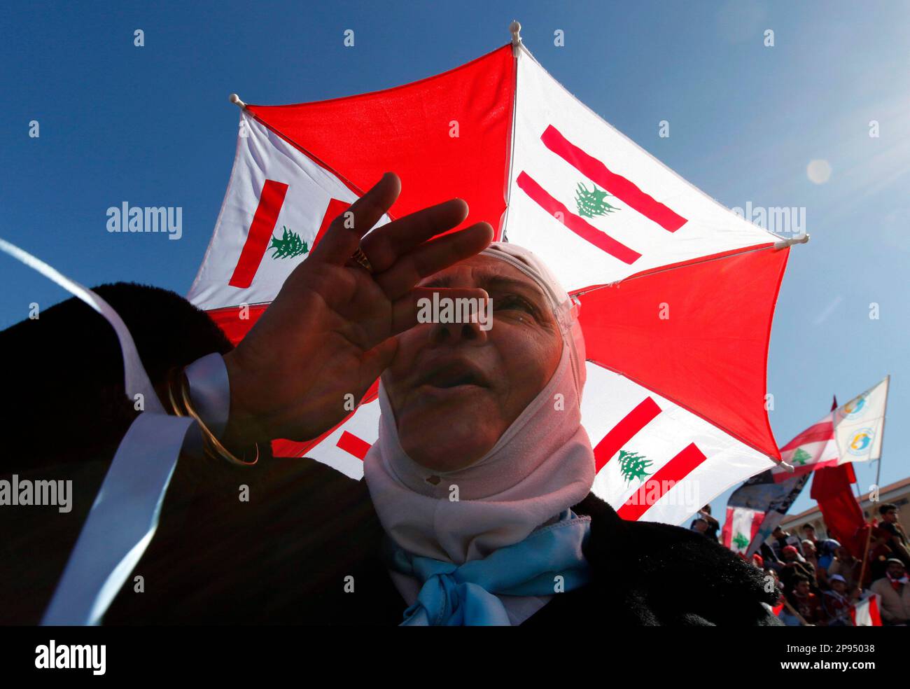 A Lebanese woman ululates, a traditional expression of emotions, as she ...