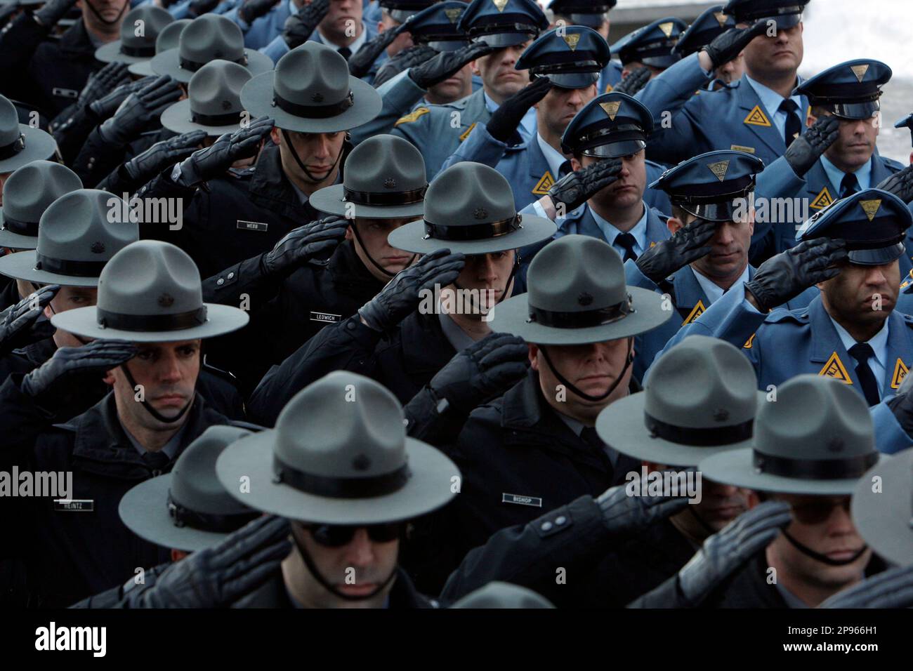 Law enforcement officers salute as the flag-draped casket of Middletown ...