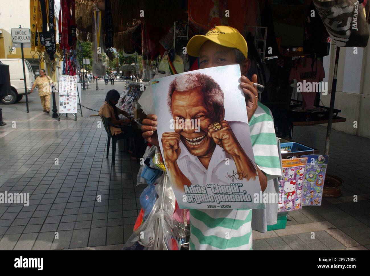A man holds a drawing portraying Puerto Rico's retired boxer Jose ...