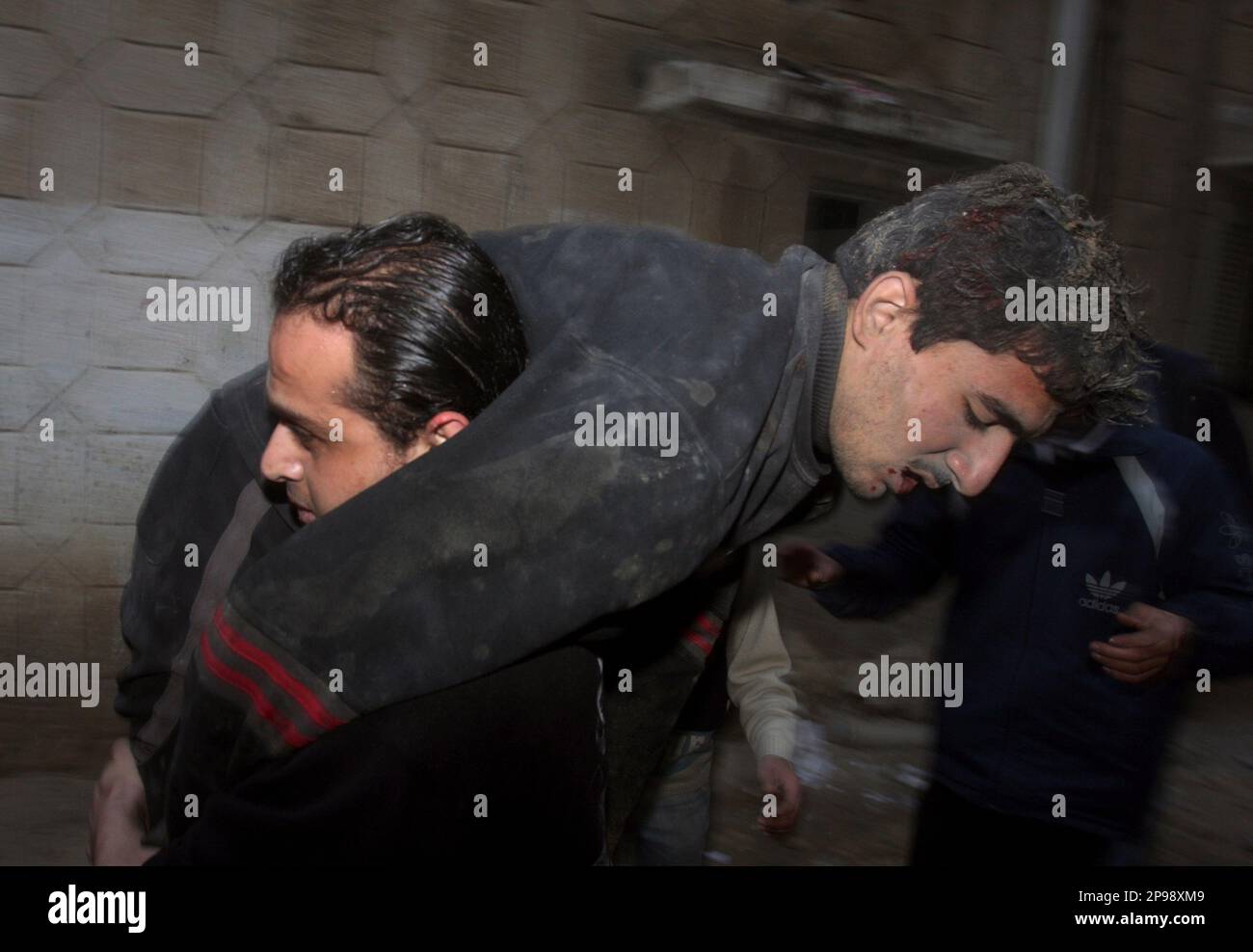 A wounded Palestinian is evacuated after an Israeli strike hit the ...
